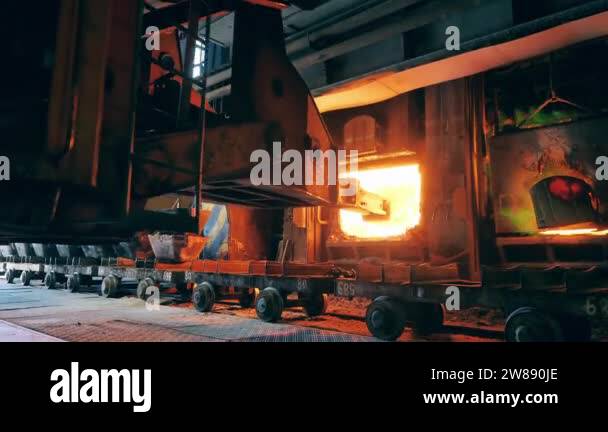 Mechanized loader is submerging copper into a smelting chamber Stock ...