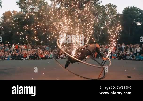actor of fire show performs trick with wheel and sparklers, sparklers ...