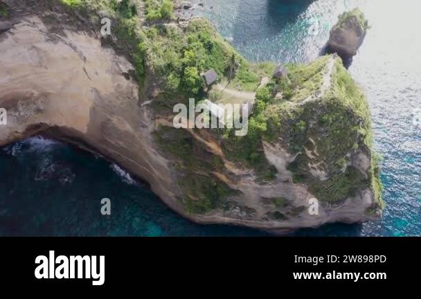 Aerial drone top down view flight over huge Atuh cliff with staircase ...