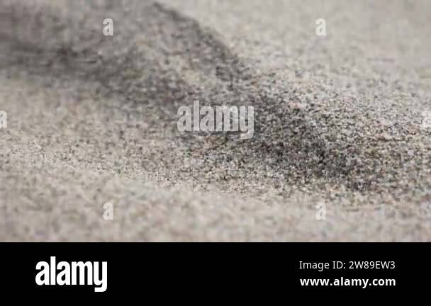 The grains of sand are blown away by a strong wind flow. Changing the ...