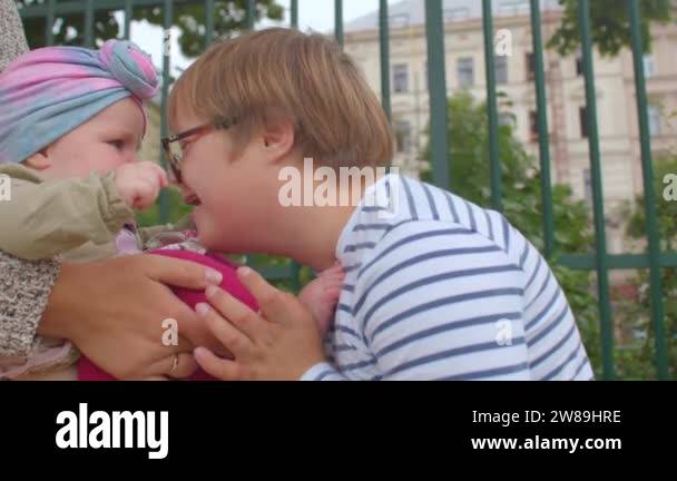 Eye contact teenager down syndrome little girl invisible bond brother ...