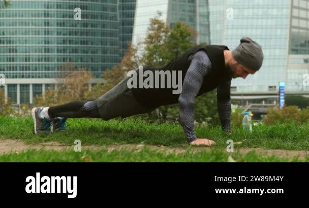 Muscular Shirtless Man Covered in Sweat Does Push-ups. Athletic , City ...