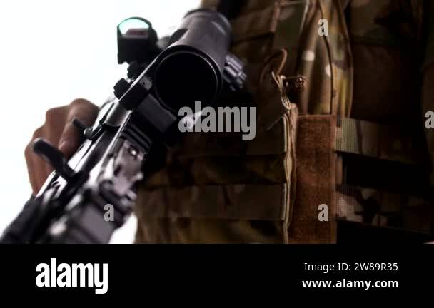 Modern combat rifle with telescopic sight and tactical armor in the ...