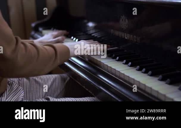 Mens hands play the piano keys at the moment of intense action. Fast ...