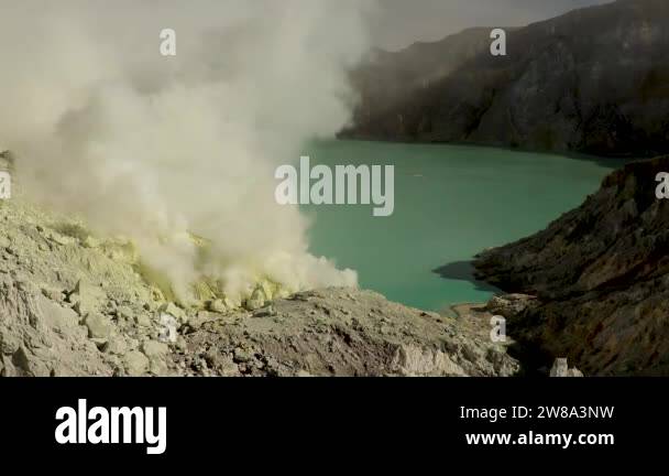 crater acid lake Kawah Ijen where sulfur is mined. Sulfur gas, smoke ...