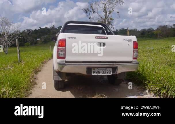 A White Toyota SUV Going on rough road at a farm Stock Video Footage ...