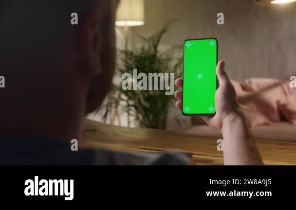 Handheld Camera: Back View of Man at Modern Room Sitting Using Phone ...