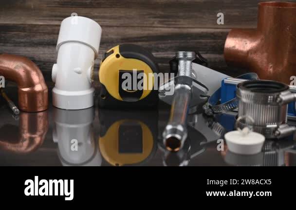 Different Plumbing supply, copper pipes and fittings over reflective ...