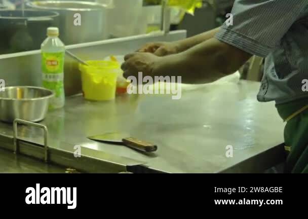 Indian man cooking roti canai at a restaurant in Kuala lumpur - Over ...