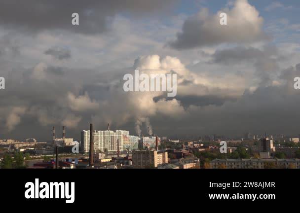 Clouds from chimneys. A lot of pipes in industrial, residential area ...