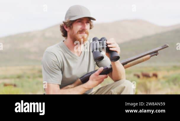 Bearded caucasian male survivalist holding hunting rifle looking using ...