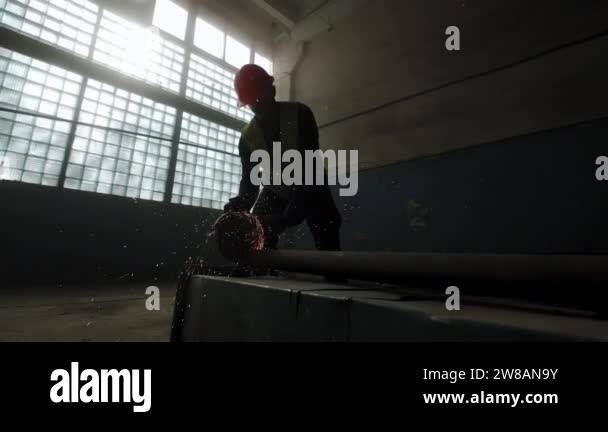 Construction worker cuts steel with a circular saw, construction ...