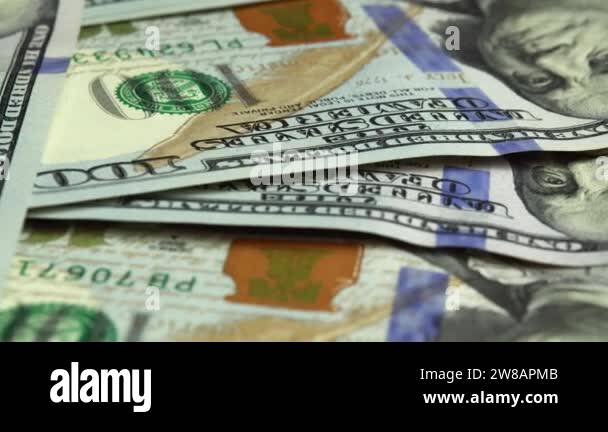 New 100 U.S dollar bills rotate as background. 100 dollar banknote in ...