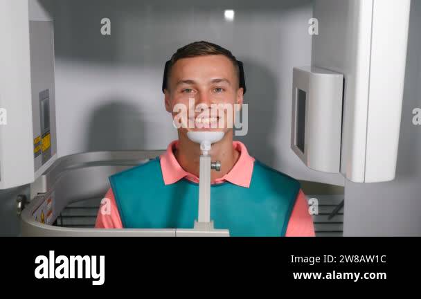 Smiling confident male patient at dentist office in mri machine. Man ...