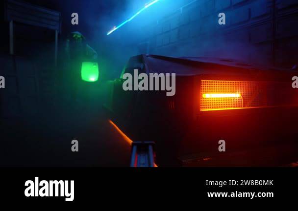 Cyberpunk concept. Futuristic car is parked on smoky street at night ...