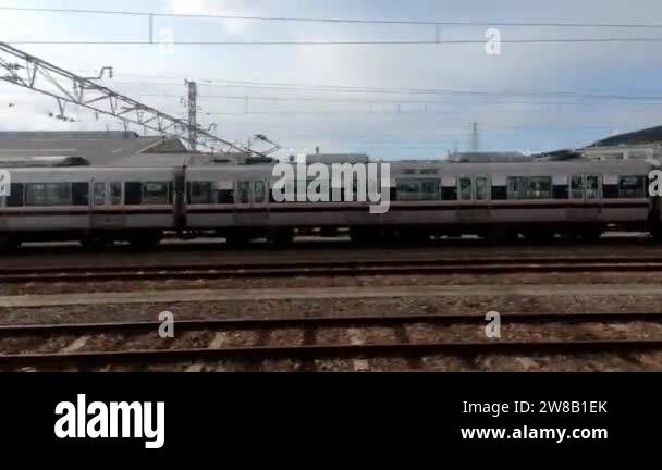 Train travels over railroad through the Kyoto city. Trains passing ...