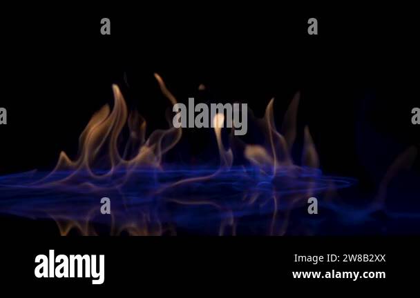Flammable liquid catches fire and burns on black studio background. Gas ...
