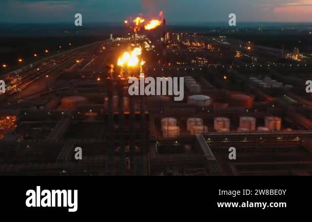 Flashes of fire are getting emitted by flare stacks at night Stock ...