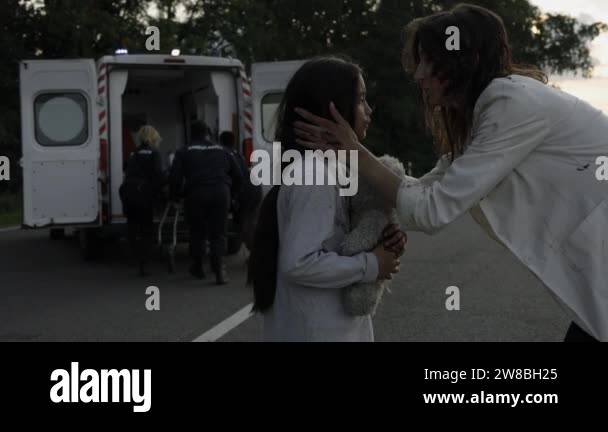 Mother hugging daughter while paramedics rescuing father Stock Video ...