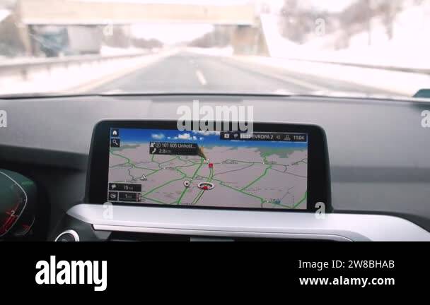 On-board computer screen of car in motion. The navigation system shows ...