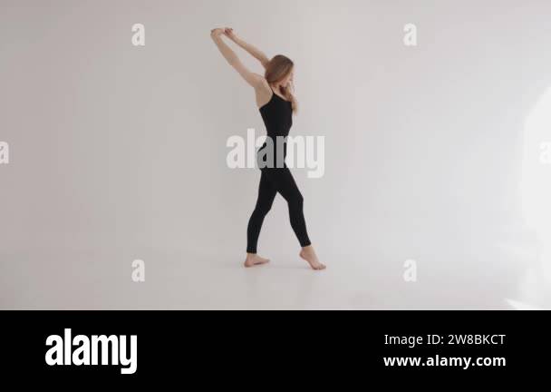 A young girl is engaged in stretching and stretches the muscles of the ...
