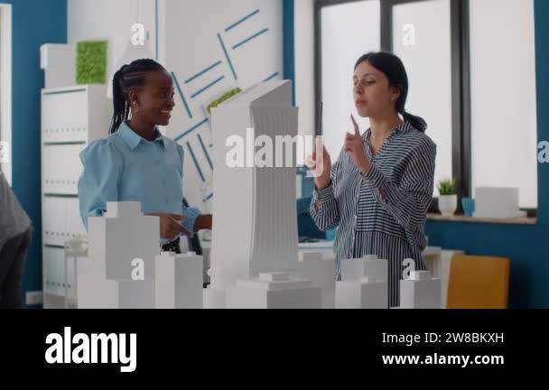 Team of women giving highfive after architecture work progress with building model Stock Video ...