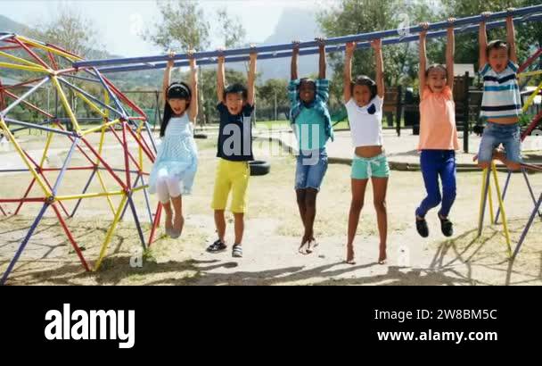 Animation of rainbow heart over diverse children playing on playground ...