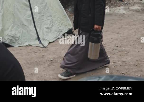 Tilting-up tracking shot of Muslim woman wearing black headscarf ...