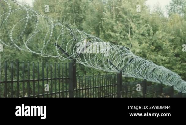 Long fence with barbed wire. The concept of closing borders and ...