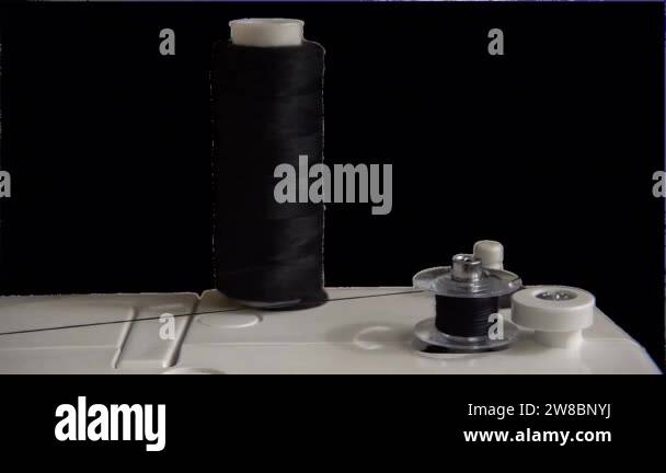 Sewing machine winding thread onto a spool. Slow motion. Alpha channel ...