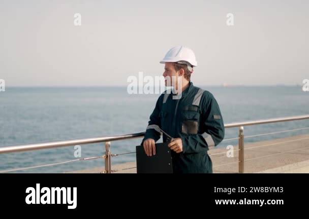 Port inspector in helmet and coverall filling vessel inspection ...