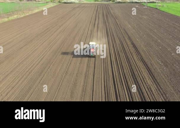Above view, tilting camera down, dolly move, of tractor as pulling ...