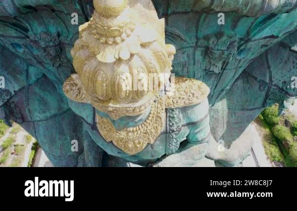 Face of Hindu deity Vishnu in Garuda Wisnu Kencana statue in Bali, Indonesia. Close up aerial ...