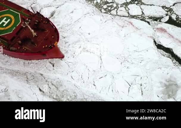 Drone top down Epic red steel icebreaker ship tanker breaks winter ...