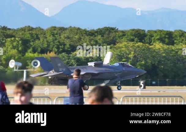 F-35B fighter jet plane short take-off on runway in front of crowd ...