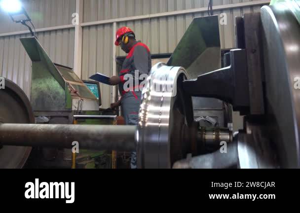 African American CNC Machine Operator Monitoring The Train Wheel ...