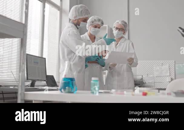 Low-angle medium of male Biracial and two female Caucasian scientists ...
