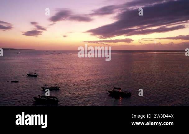 Shiny golden sunset with yellow sky and sun rays through grey clouds ...