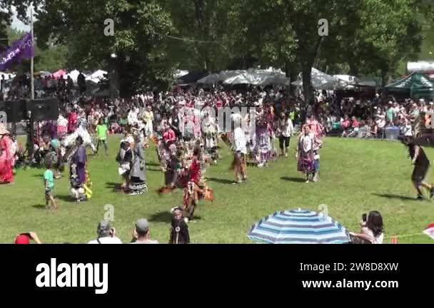People of all nations dancing at a Native American dance contest at a ...