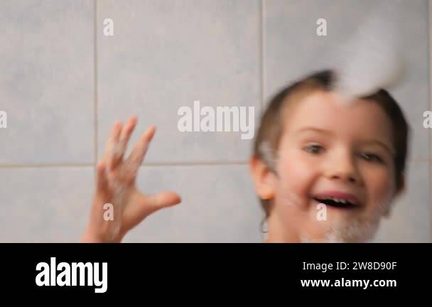 Foam on head boy making funny face close up child taking bath children ...