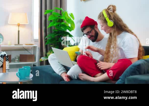 In the large modern living room a happy and good looking couple spring ...