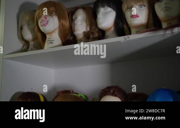 3 shelves of wigs in different hairstyles,haircuts dyed in various ...