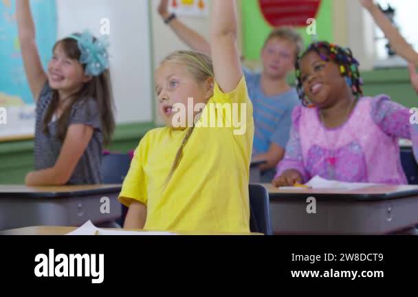 Students raise hands in school classroom Stock Video Footage - Alamy
