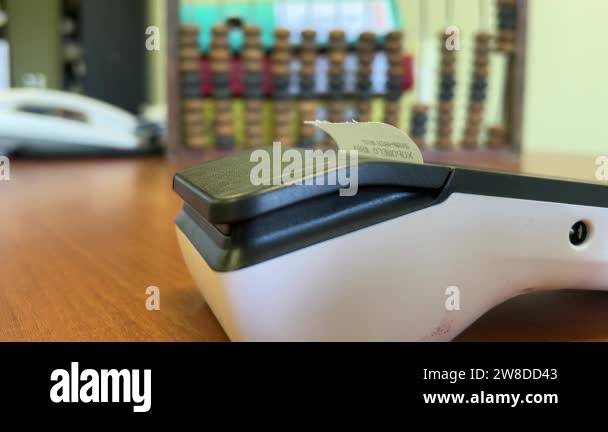 The terminal is a POS cash register for payments and a long roll of ...