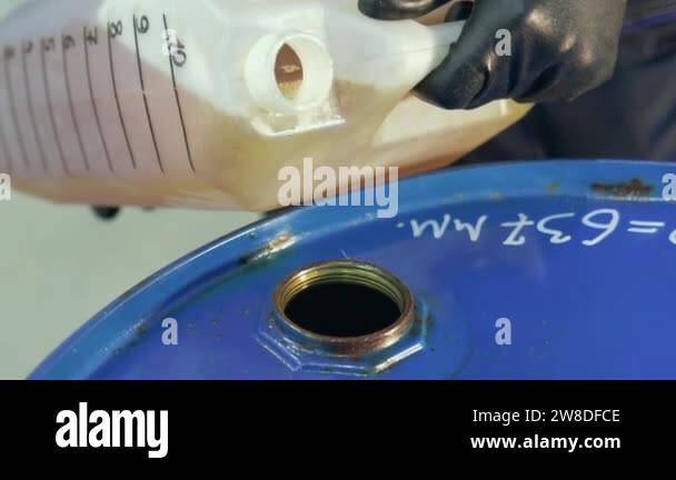 Inside the room at the gas station from the canister pour engine oil ...