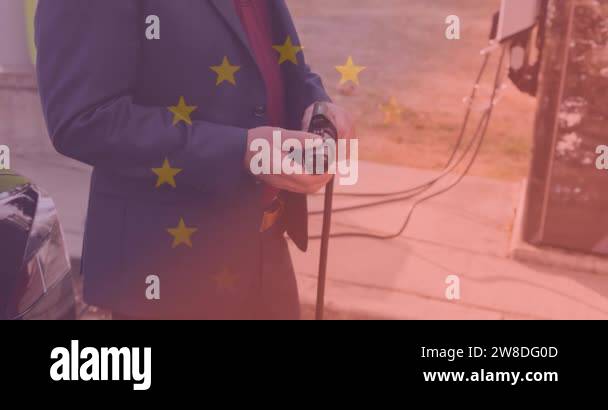 Flag of european union over man charing electric car. ev charging ...