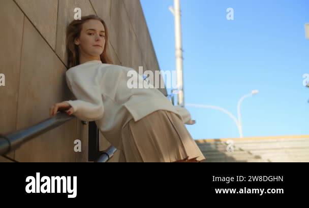 Model with long legs and dressed in mini are posing in slow motion in ...