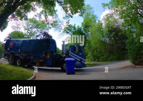 Republic Services garbage truck collect trash and recycle dust bins in ...