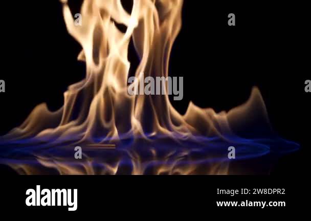 Falling match causes flames to ignite against black studio background ...