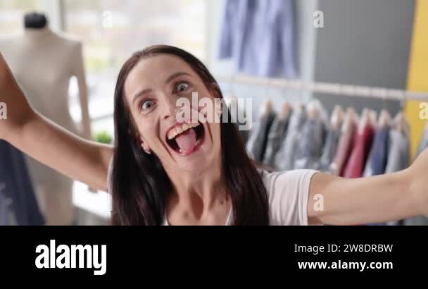 Young woman laughing and fooling around in dry cleaning 4k movie Stock ...